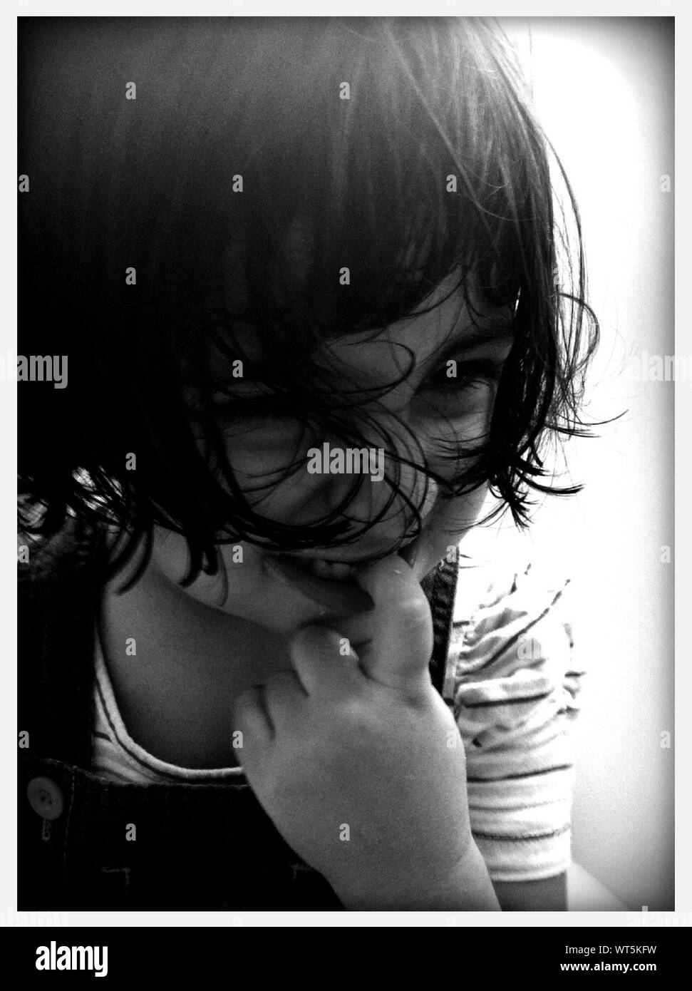 Biting your finger Black and White Stock Photos & Images - Alamy