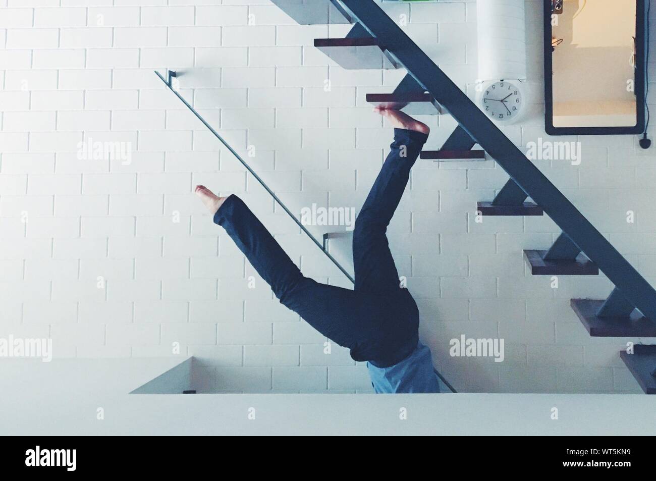 Young man walking down stairs hi-res stock photography and images - Alamy