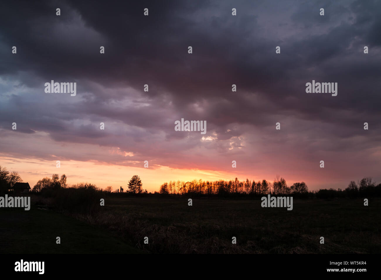 Sunset under the clouds Stock Photo - Alamy