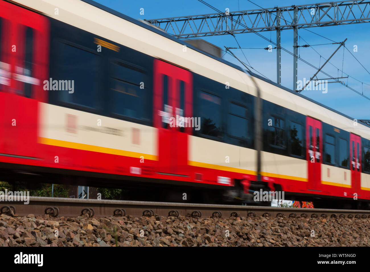 Speeding Train on suburban rails Stock Photo - Alamy