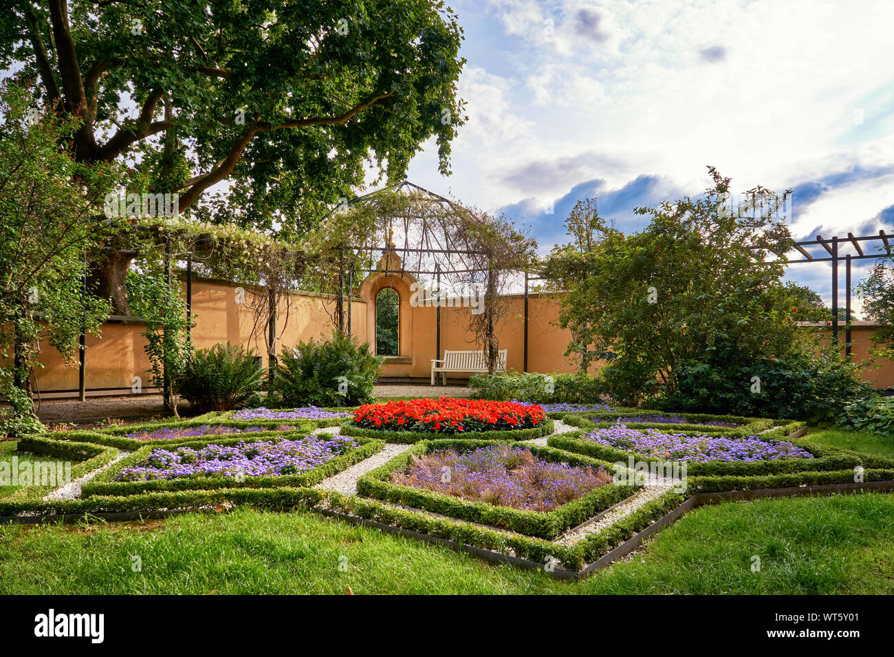 Romantic old garden with colorful flowers Stock Photo - Alamy