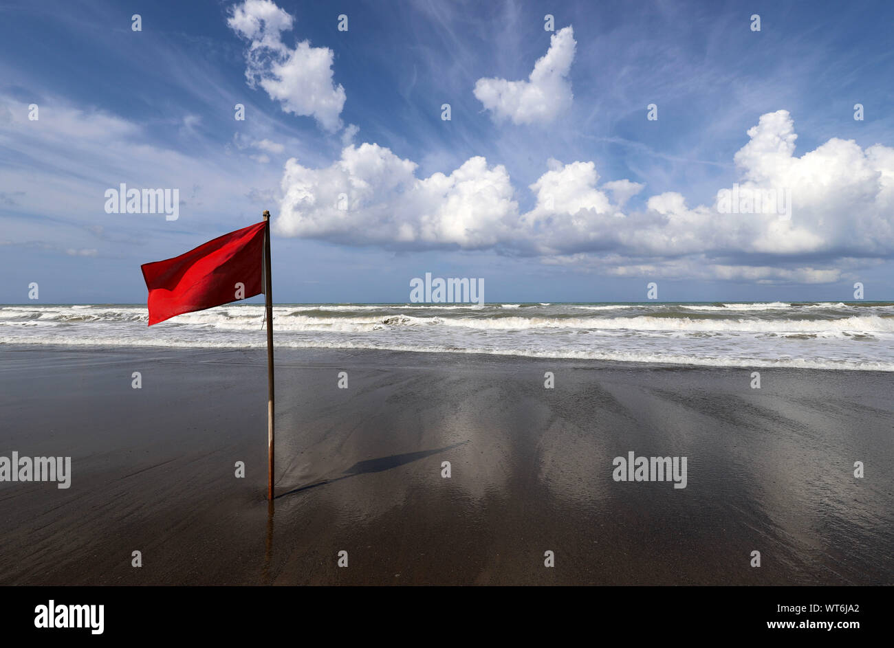 Red flag for rough seas along an Italian beach Stock Photo - Alamy