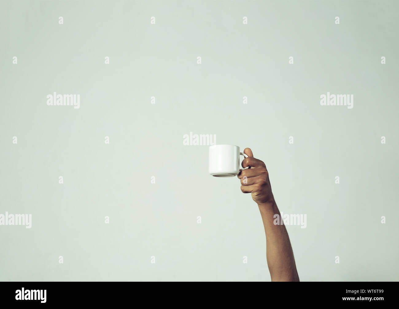 hand holding cup of coffee against white background Stock Photo - Alamy