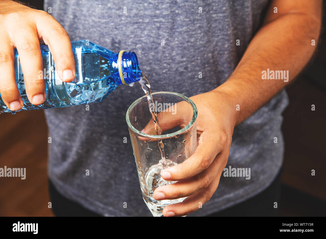 person pouring water in glass over white background - healthy lifestyle ...