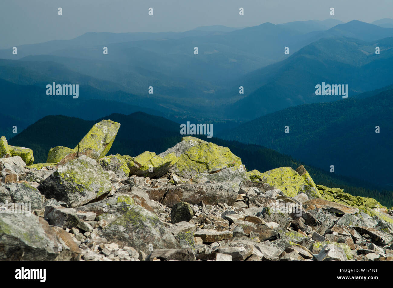 Crest of the mountain range with stone placers covered with green ...