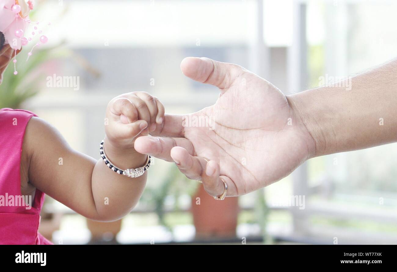 Baby hand holding finger ring hi-res stock photography and images - Alamy