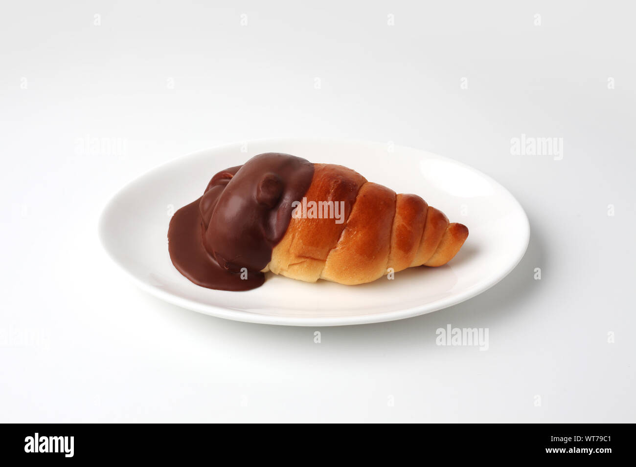 chocolate cornet roll bread on plate closeup isolated on white ...