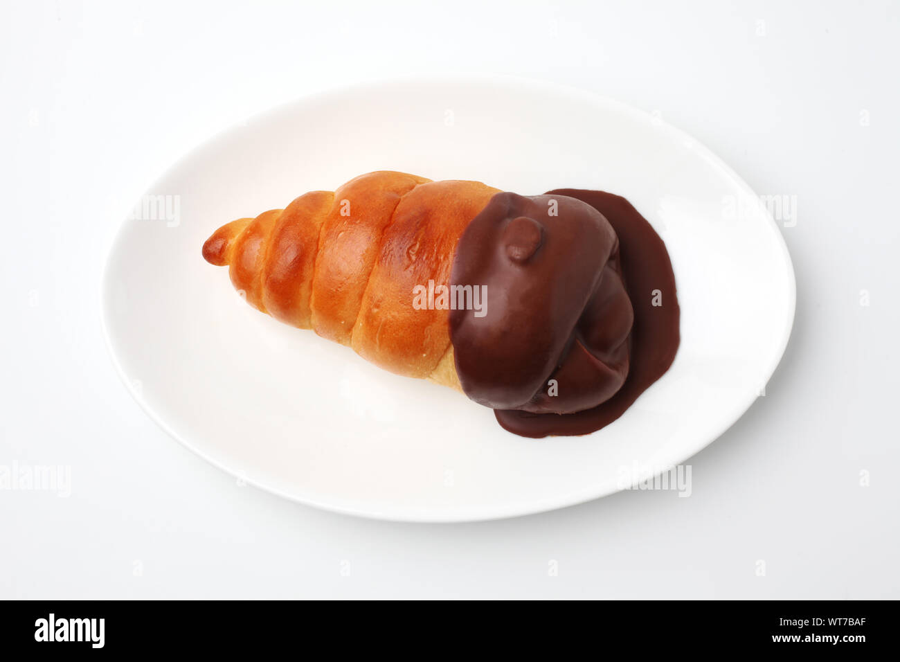 chocolate cornet roll bread on plate closeup isolated on white ...
