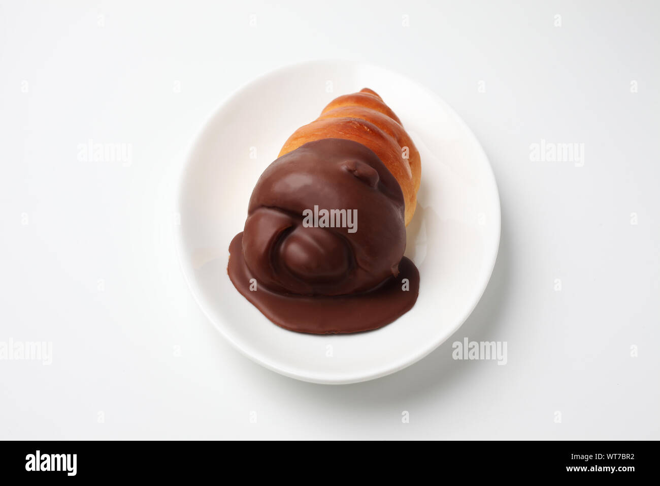 chocolate cornet roll bread on plate closeup isolated on white ...