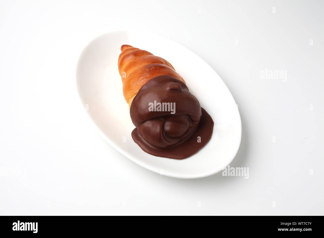 chocolate cornet roll bread on plate closeup isolated on white ...