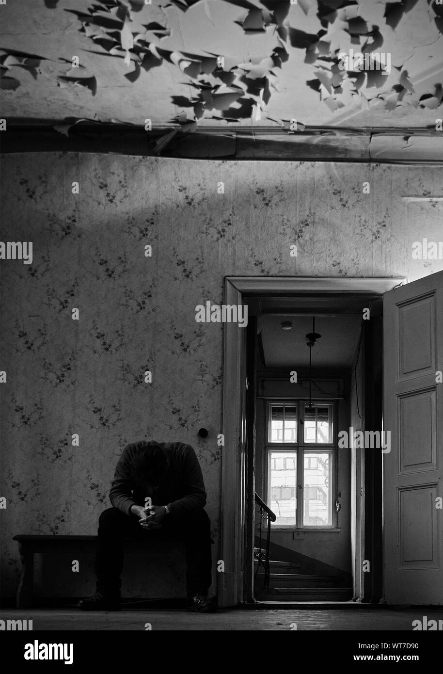 Man sitting in empty hi-res stock photography and images - Alamy