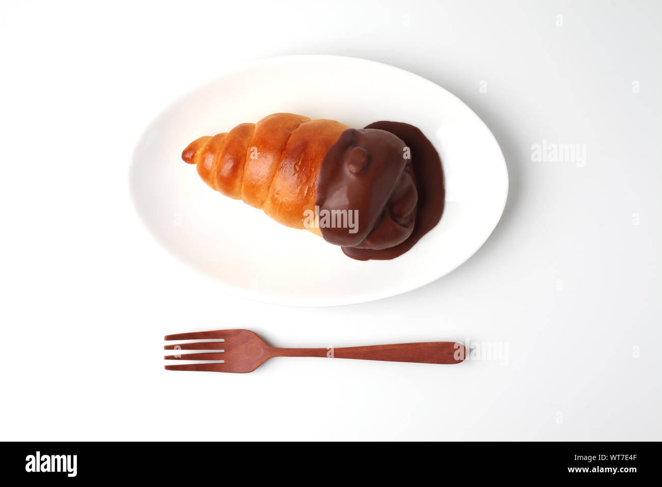 chocolate cornet roll bread on plate closeup isolated on white ...