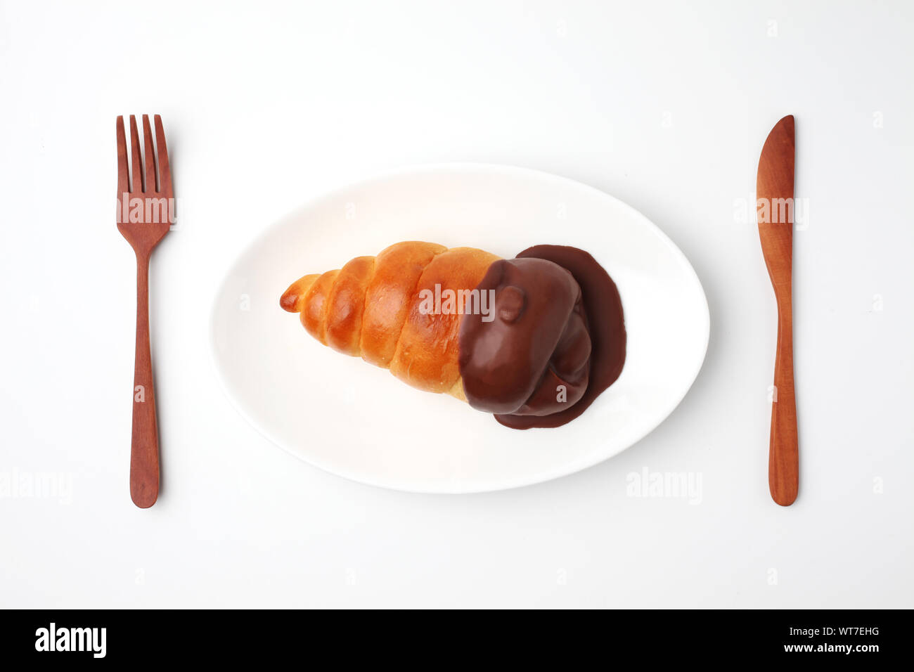 chocolate cornet roll bread on plate closeup isolated on white ...