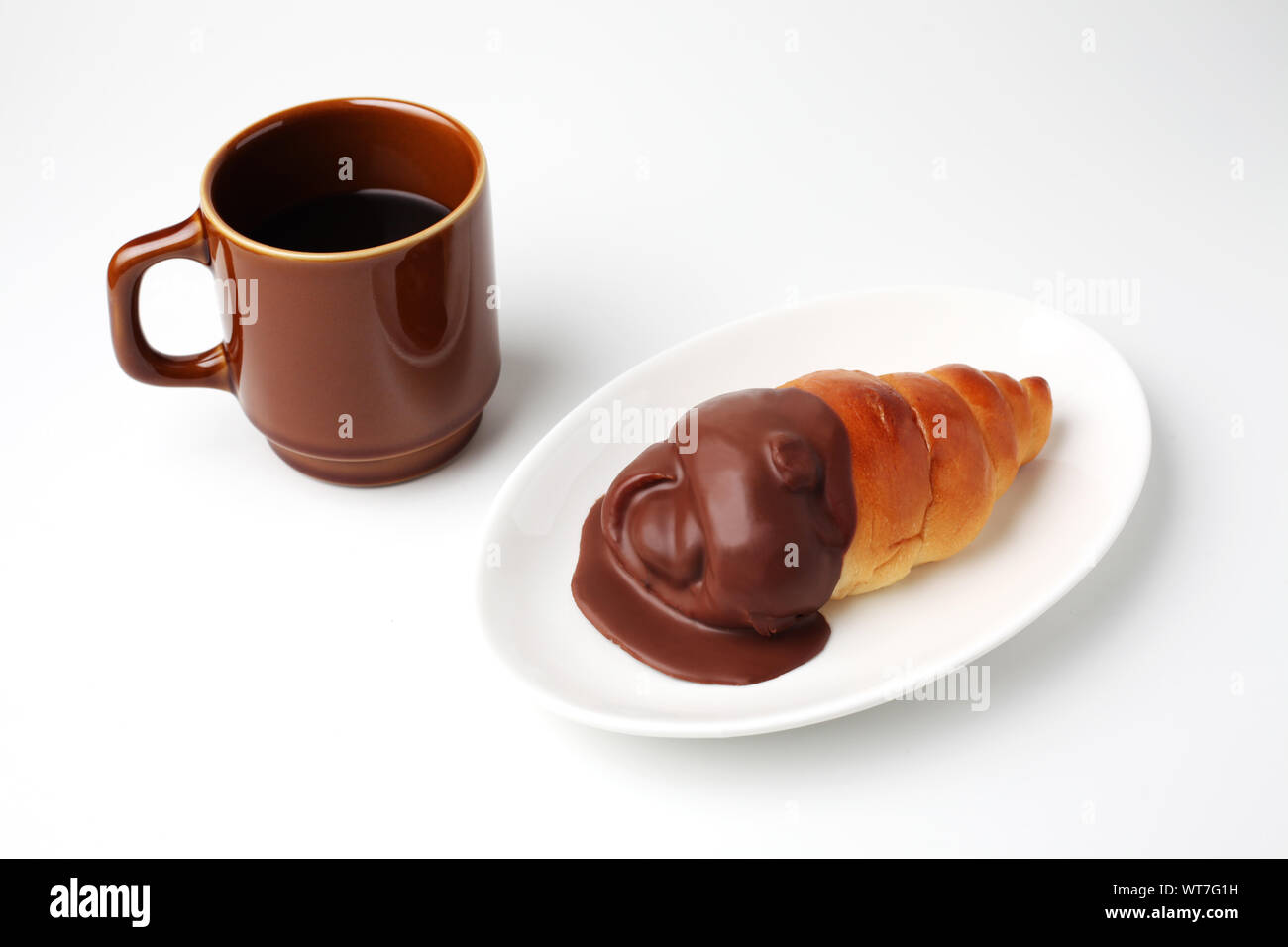 chocolate cornet roll bread on plate closeup isolated on white ...