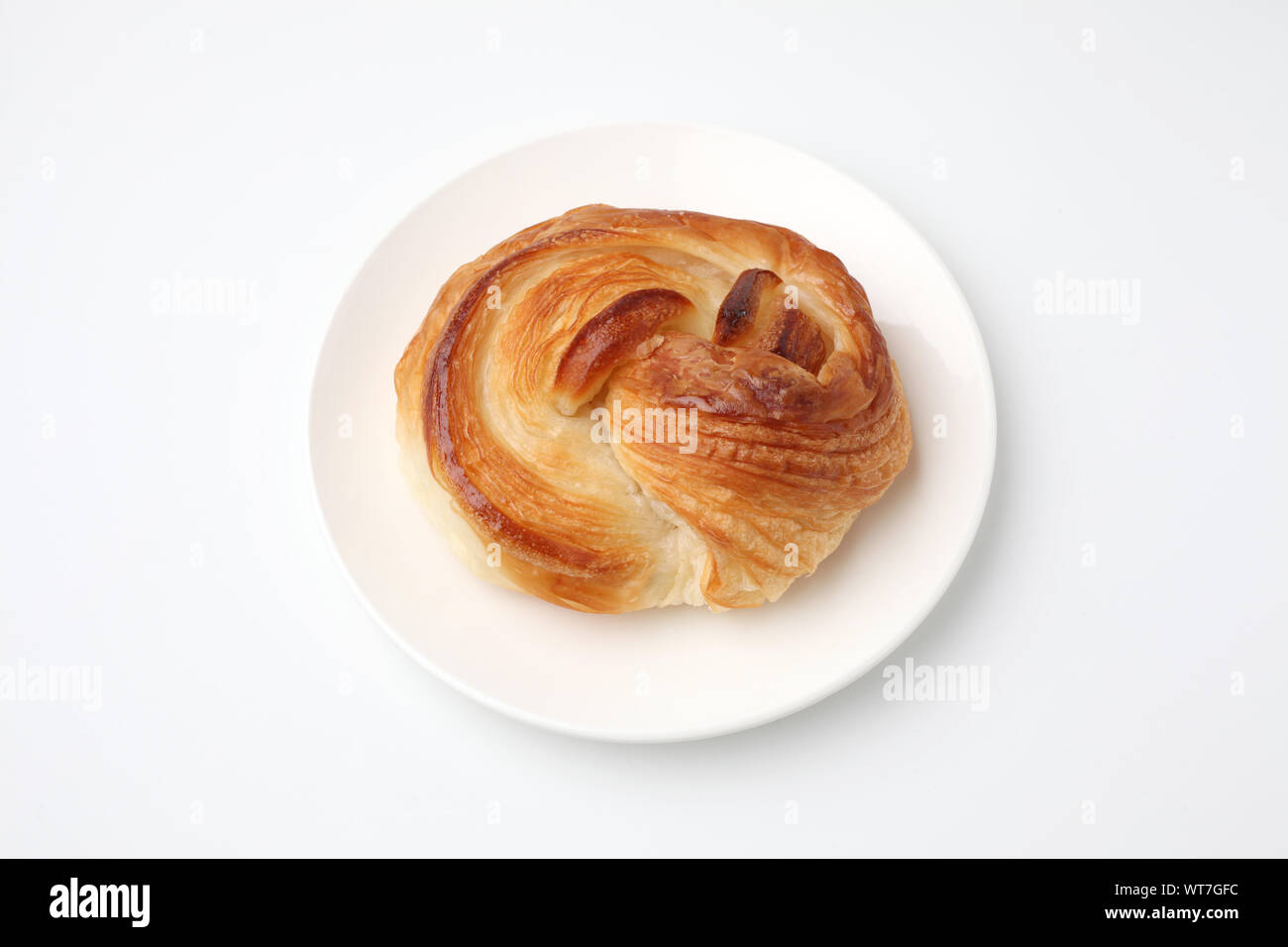 round danish bread on plate closeup isolated on white background Stock ...
