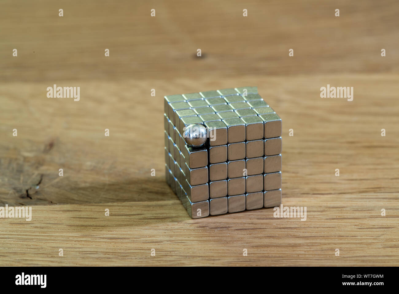 metal ball in a cube of square magnets Stock Photo - Alamy