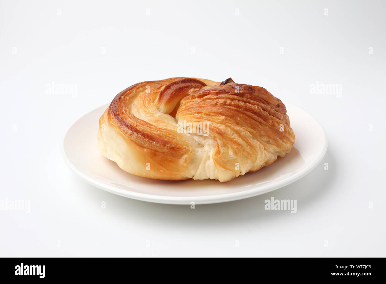 round danish bread on plate closeup isolated on white background Stock ...