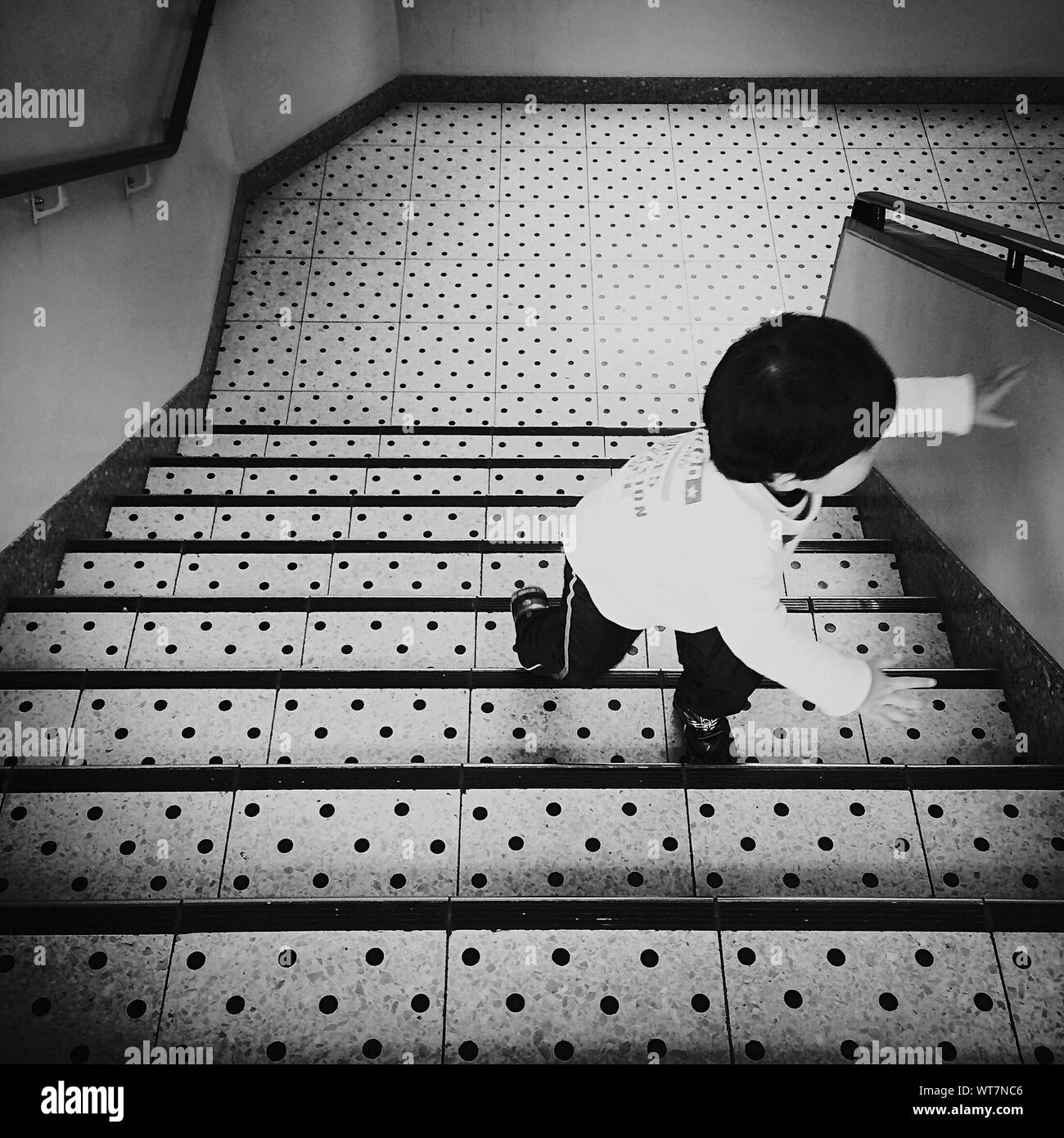 Boy walking up stairs hi-res stock photography and images - Alamy