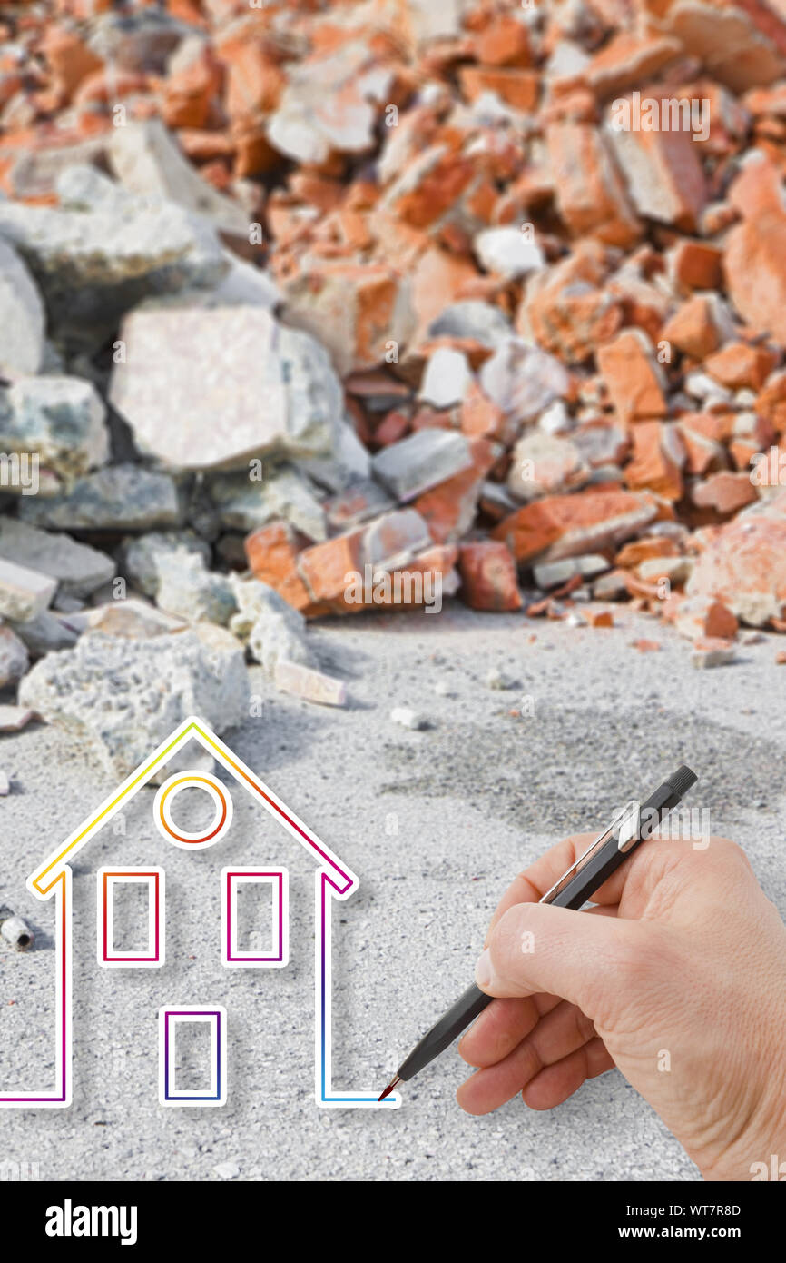 Hand drawing a colored house against a concrete and brick rubble debris ...