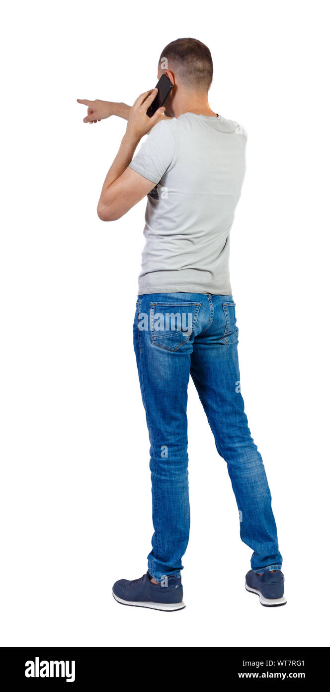 Back view of pointing young men talking on cell phone. Young guy ...