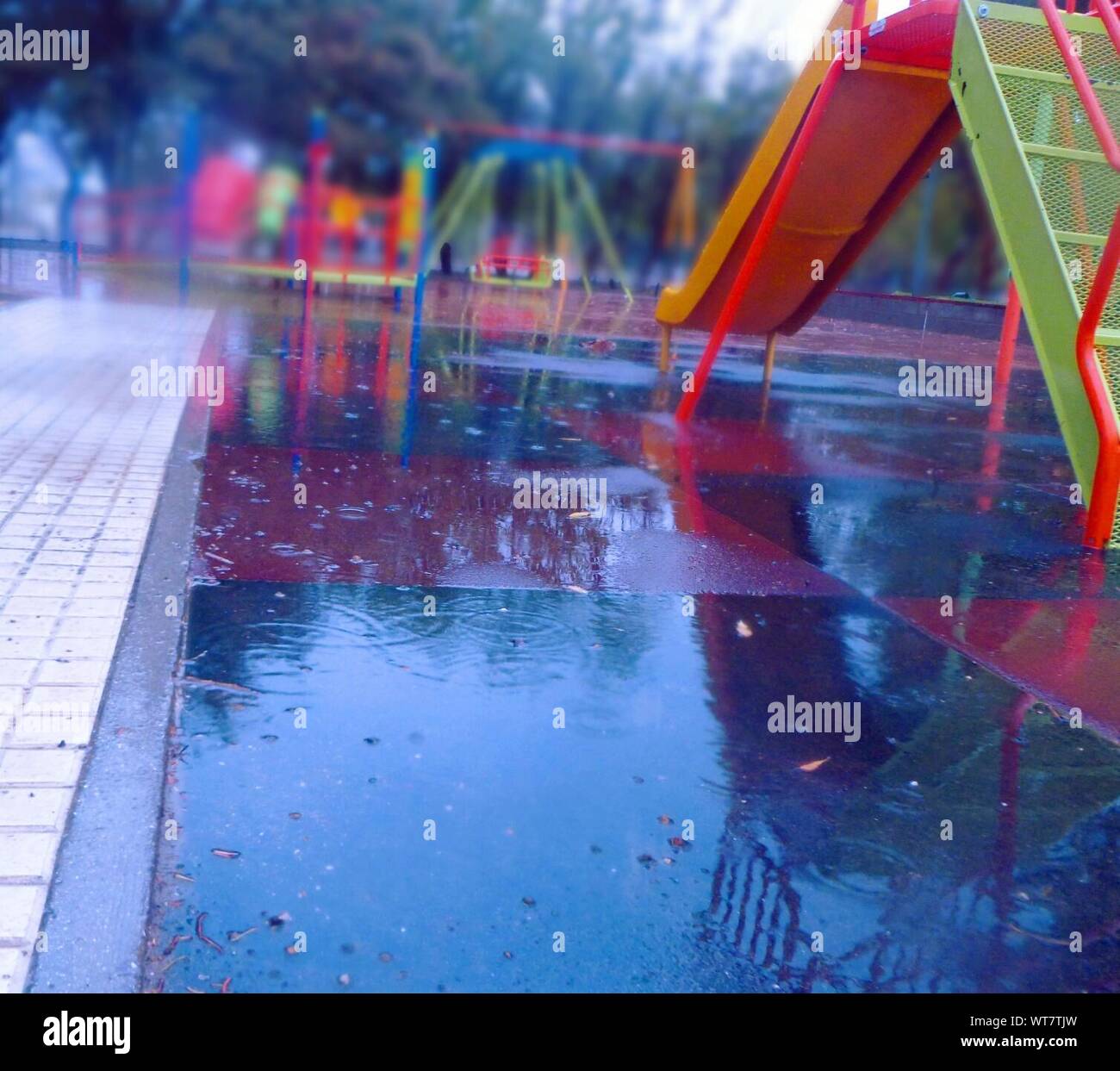 Slide playground rain hi-res stock photography and images - Alamy