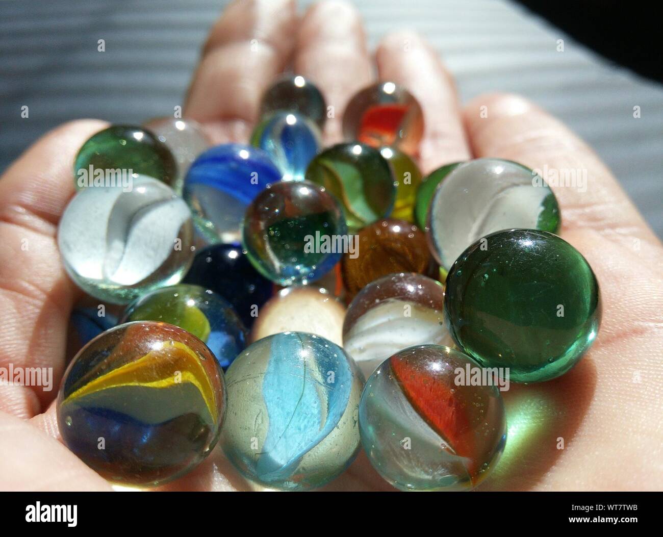 Hand holding marbles hi-res stock photography and images - Alamy