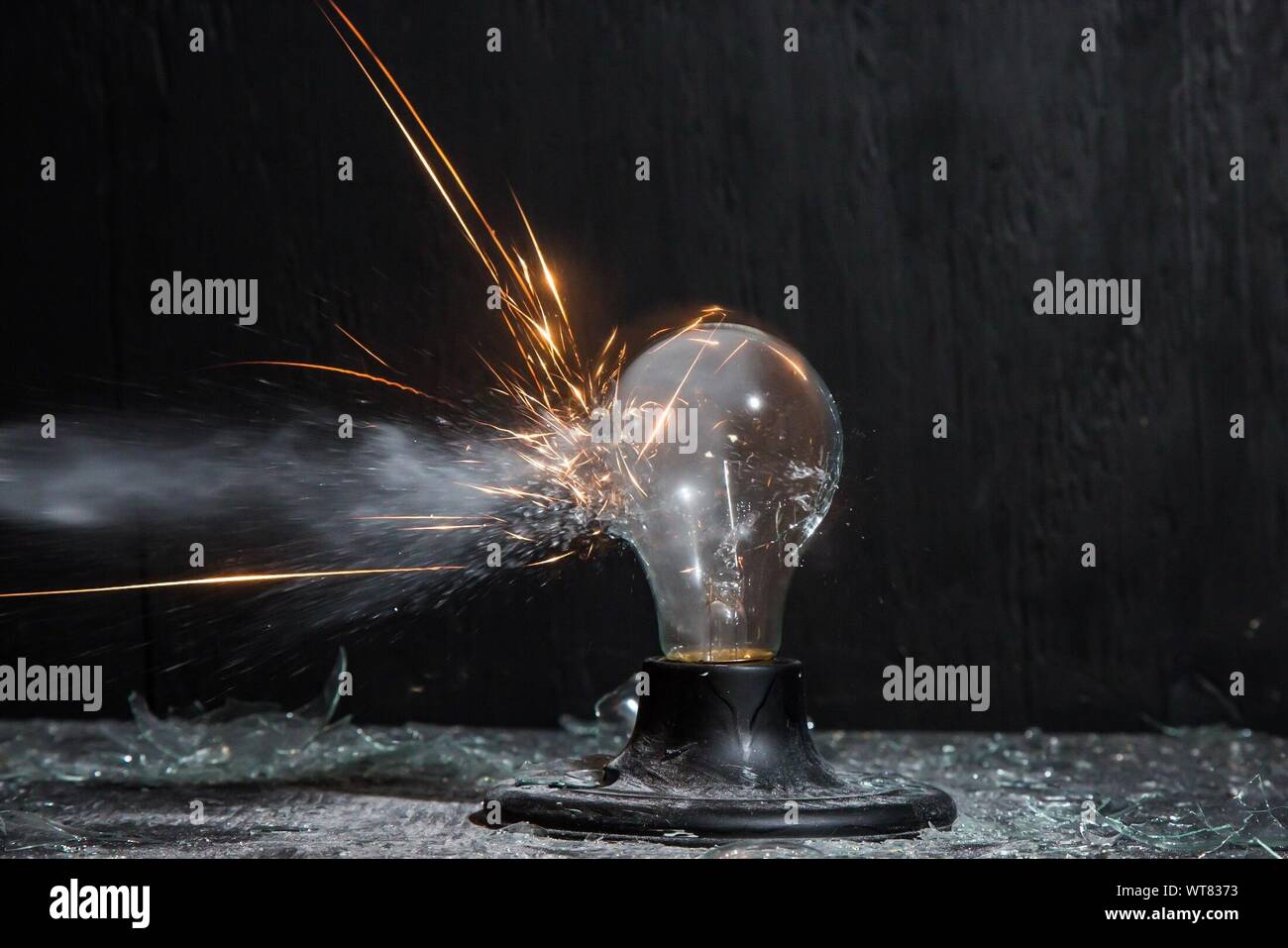 Glowing light bulb and sparks hi-res stock photography and images - Alamy