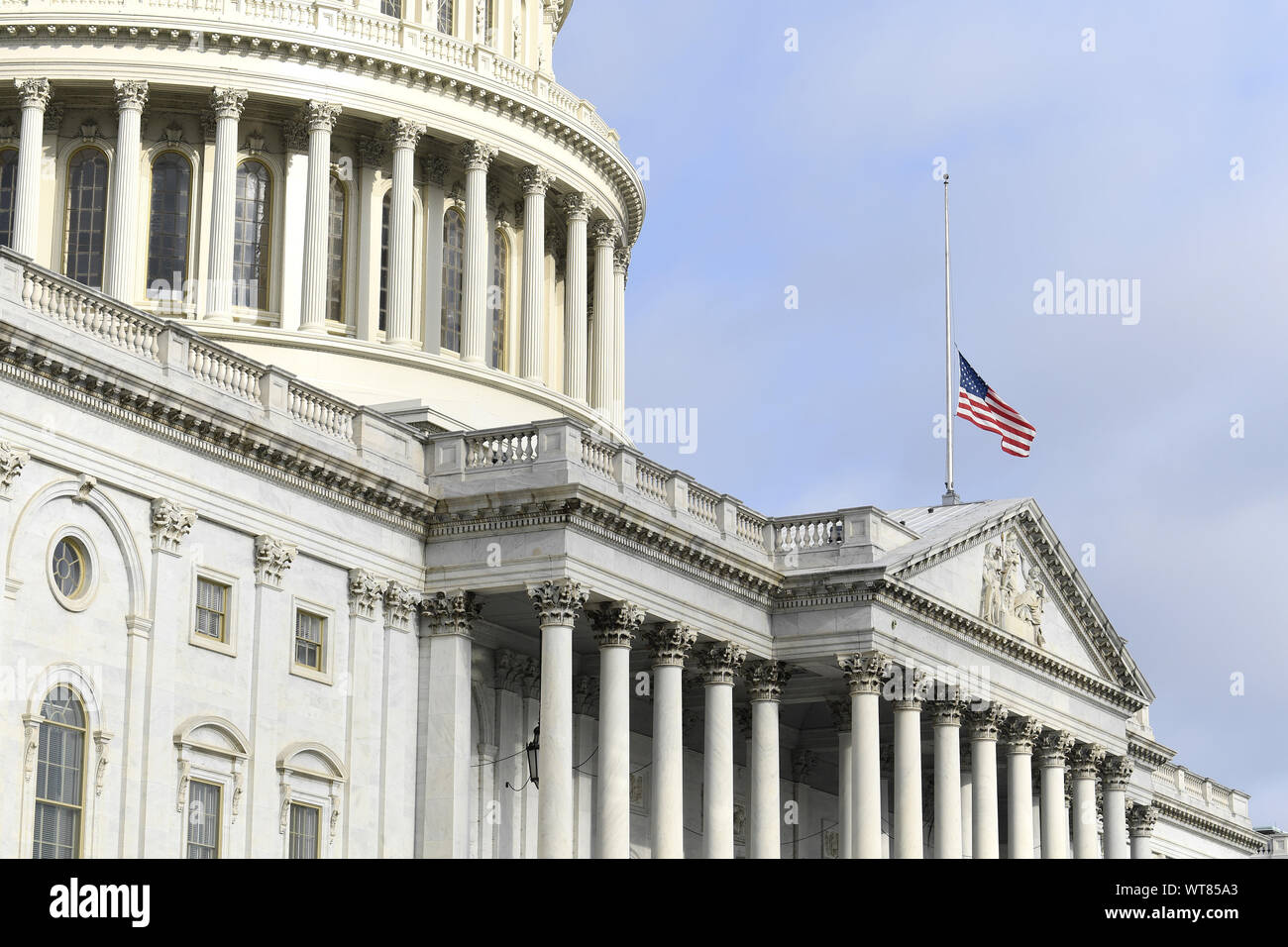The American flag flies half-staff on a pediment of the US Capitol for ...