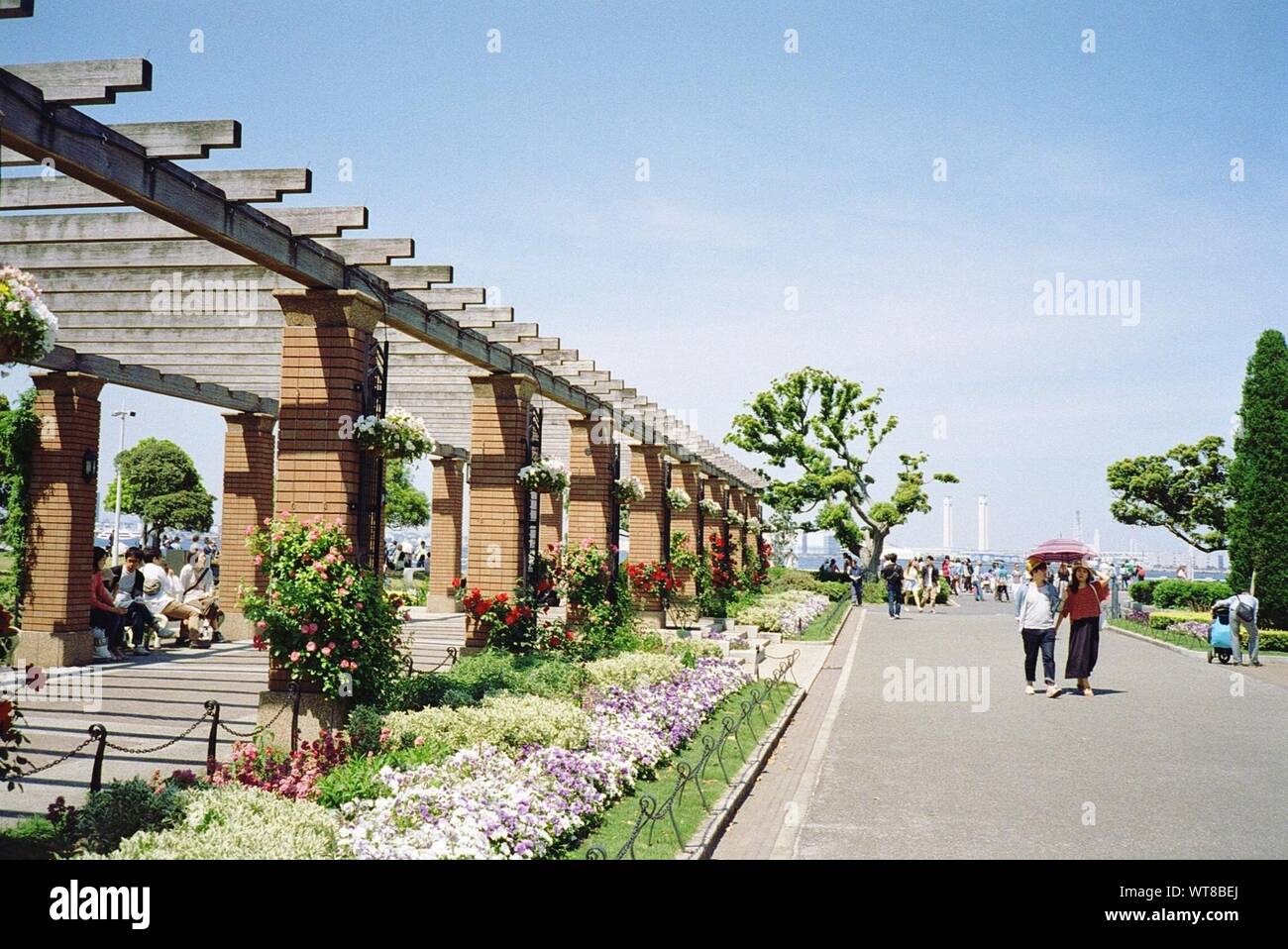 People Walking On Pathway By Built Structure Stock Photo - Alamy