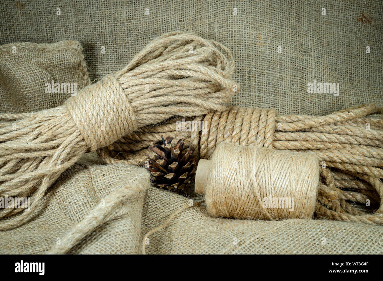 Spools of burlap threads or jute twine, sackcloth fabric in close-up on ...