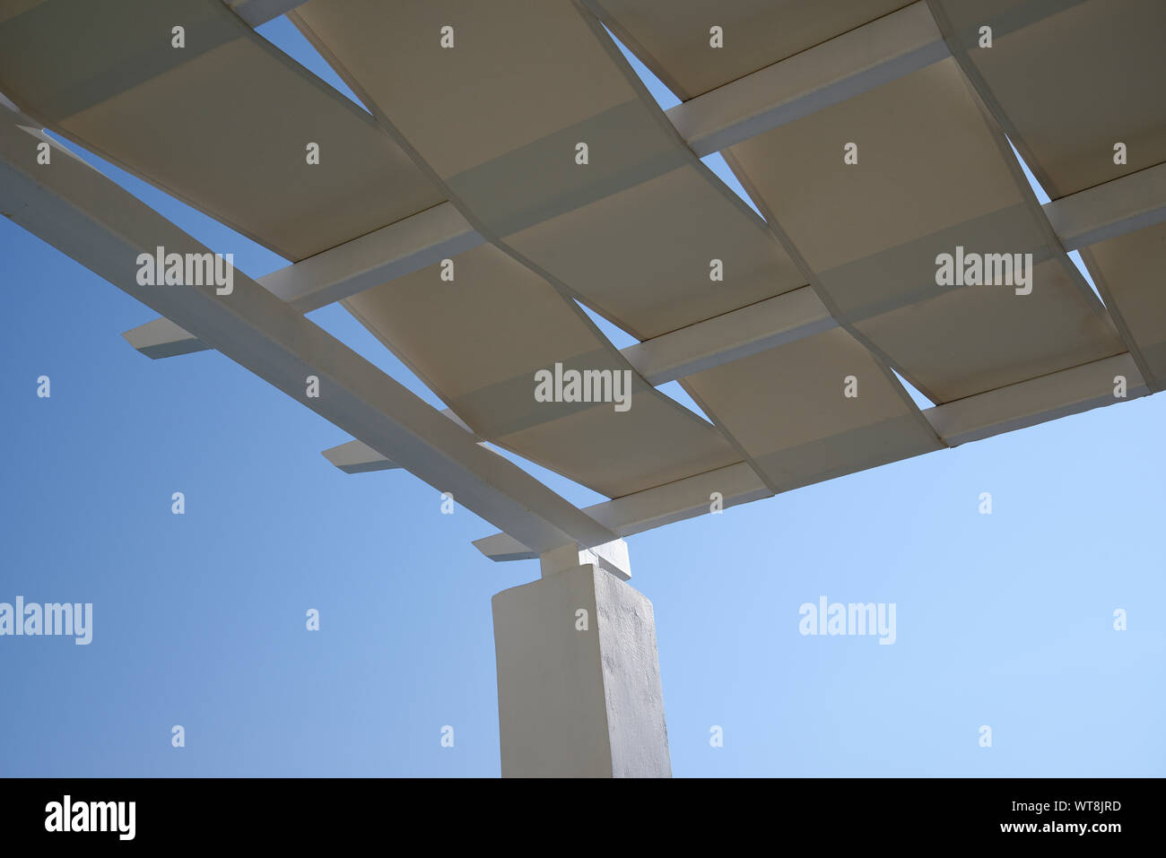 Abstract composition of sun shade canvas on a metal frame, with blue ...