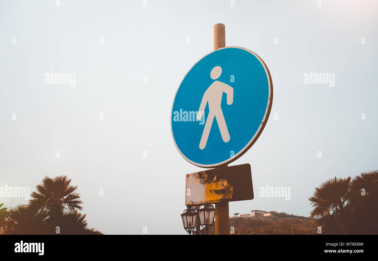 blue pedestrians traffic sign in rotten look Stock Photo - Alamy