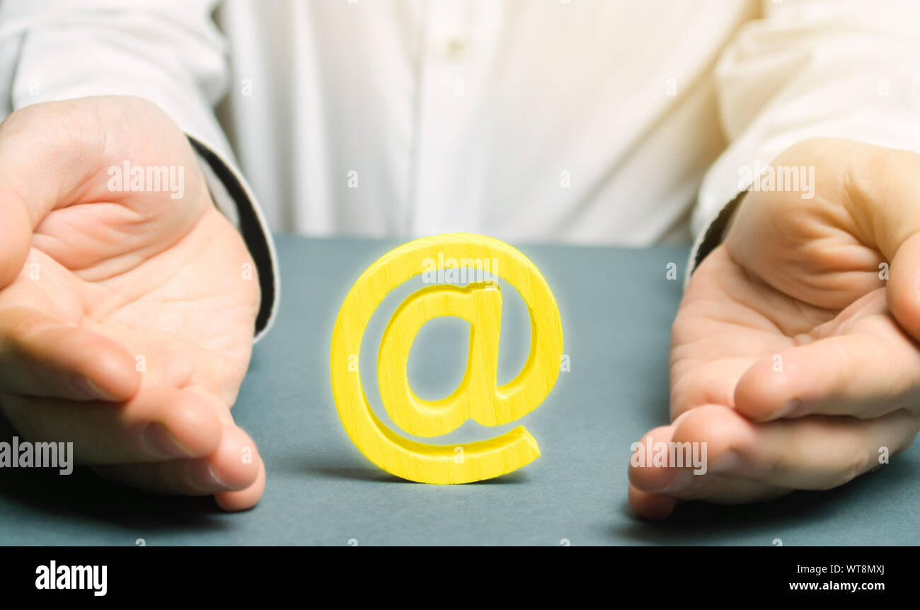 A man wraps his hands around an email symbol. Keeping the Internet open ...