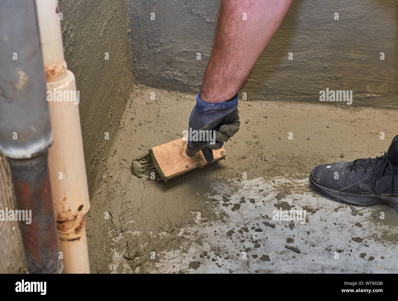 Applying layer of isolation material with a brush on a floor Stock ...