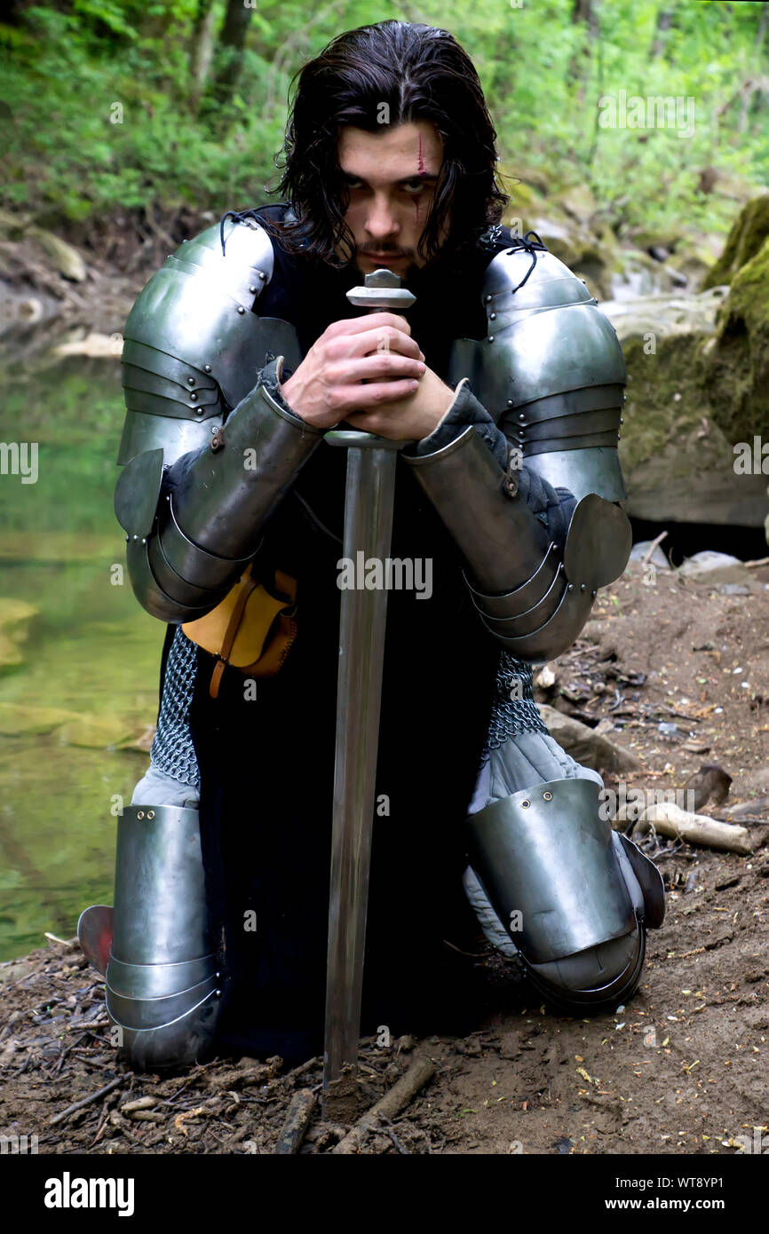 Leaning on sword hi-res stock photography and images - Alamy