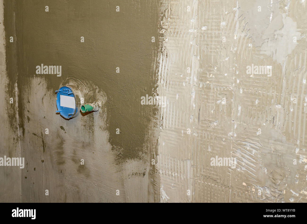 Wall during renovation works partly with a layer of isolation material ...