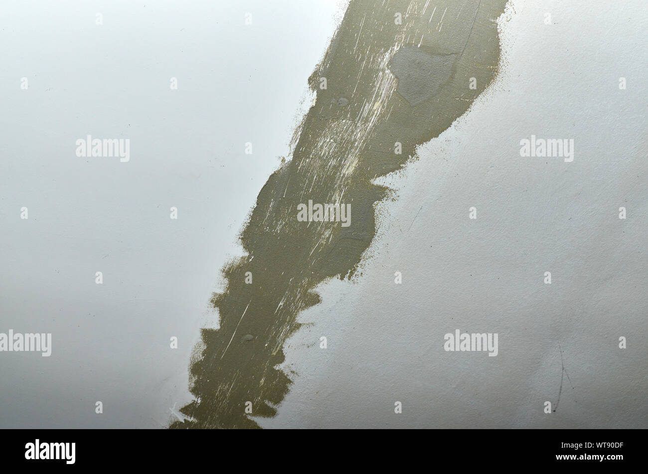 Ceiling partly with a layer of a mortar during renovation works in an ...