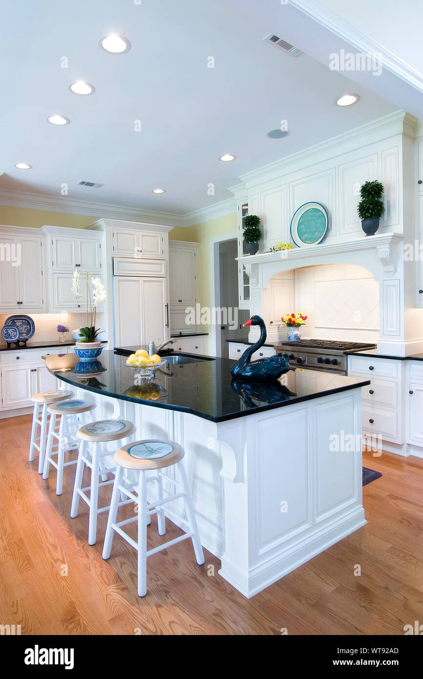 trendy expensive kitchen with white and oak Stock Photo - Alamy