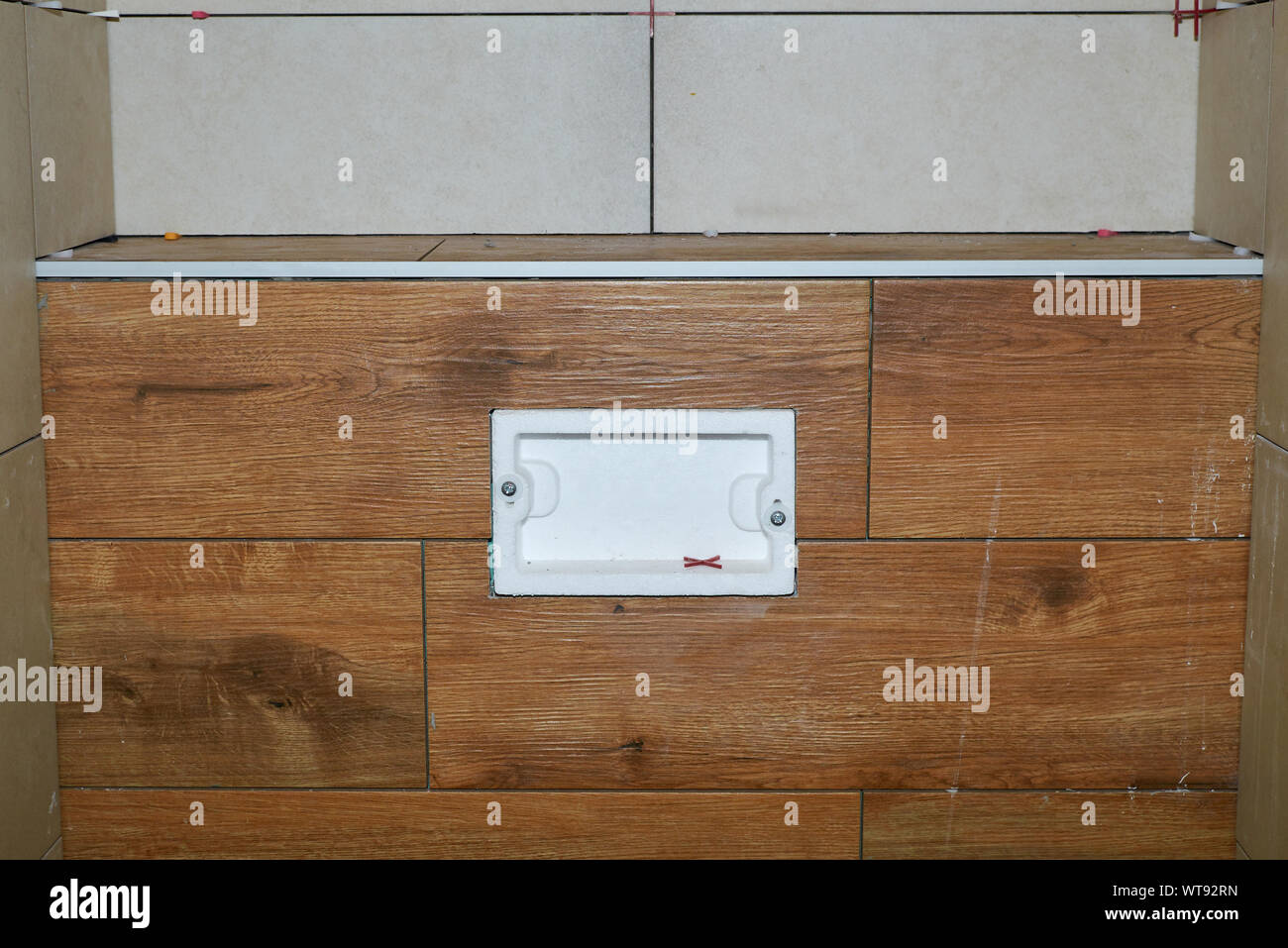 Tiles with wooden look and toilet flush system inside it Stock Photo ...