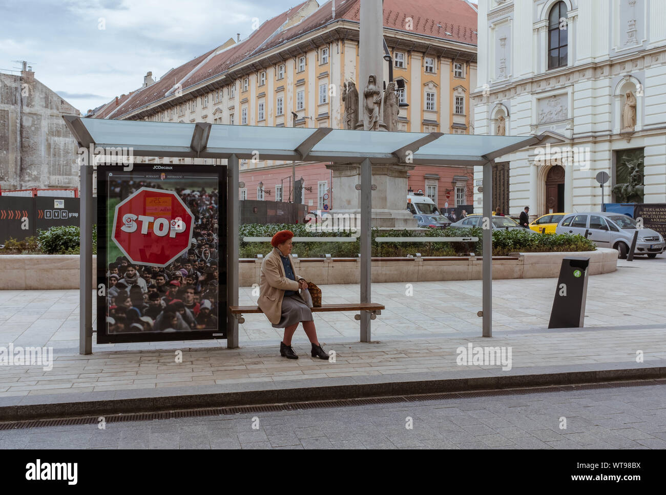 Elderly woman sitting bus stop hi-res stock photography and images - Alamy