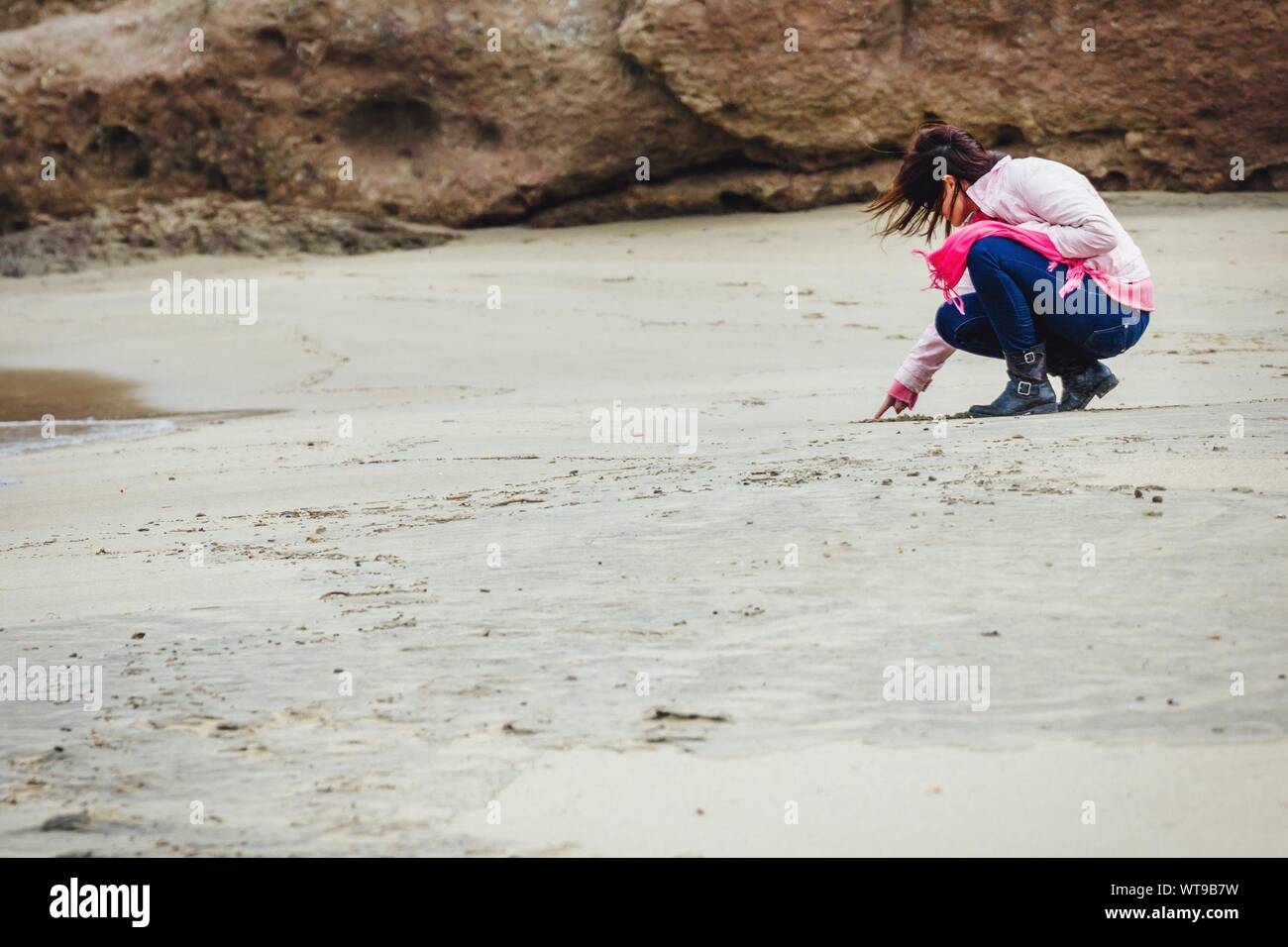 Crouching beach hi-res stock photography and images - Alamy