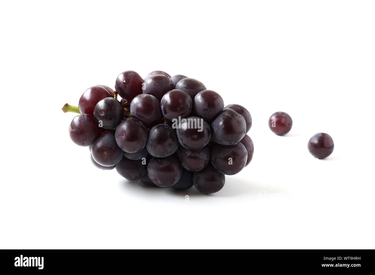 fresh bunch of grapes on plate closeup isolated on white background ...