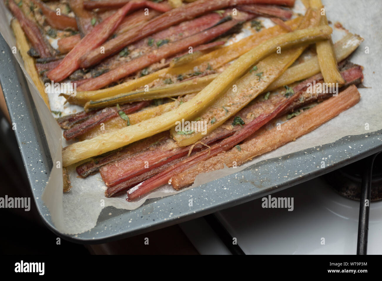 Tray of oven roasted chard gratin with Italian herbs on cooker top ...