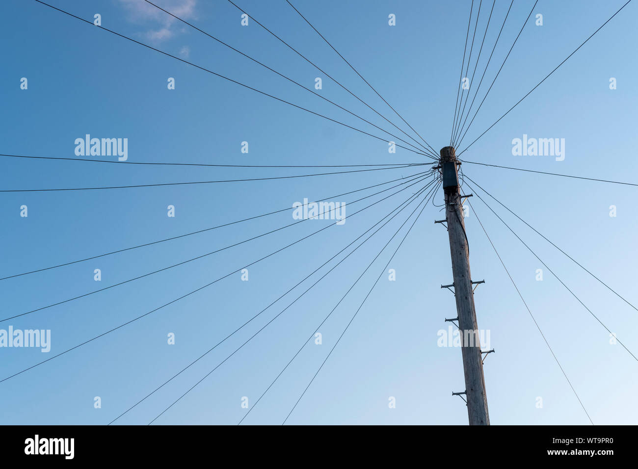 Network communication cables on electric pole agains blue sky, Epsom ...