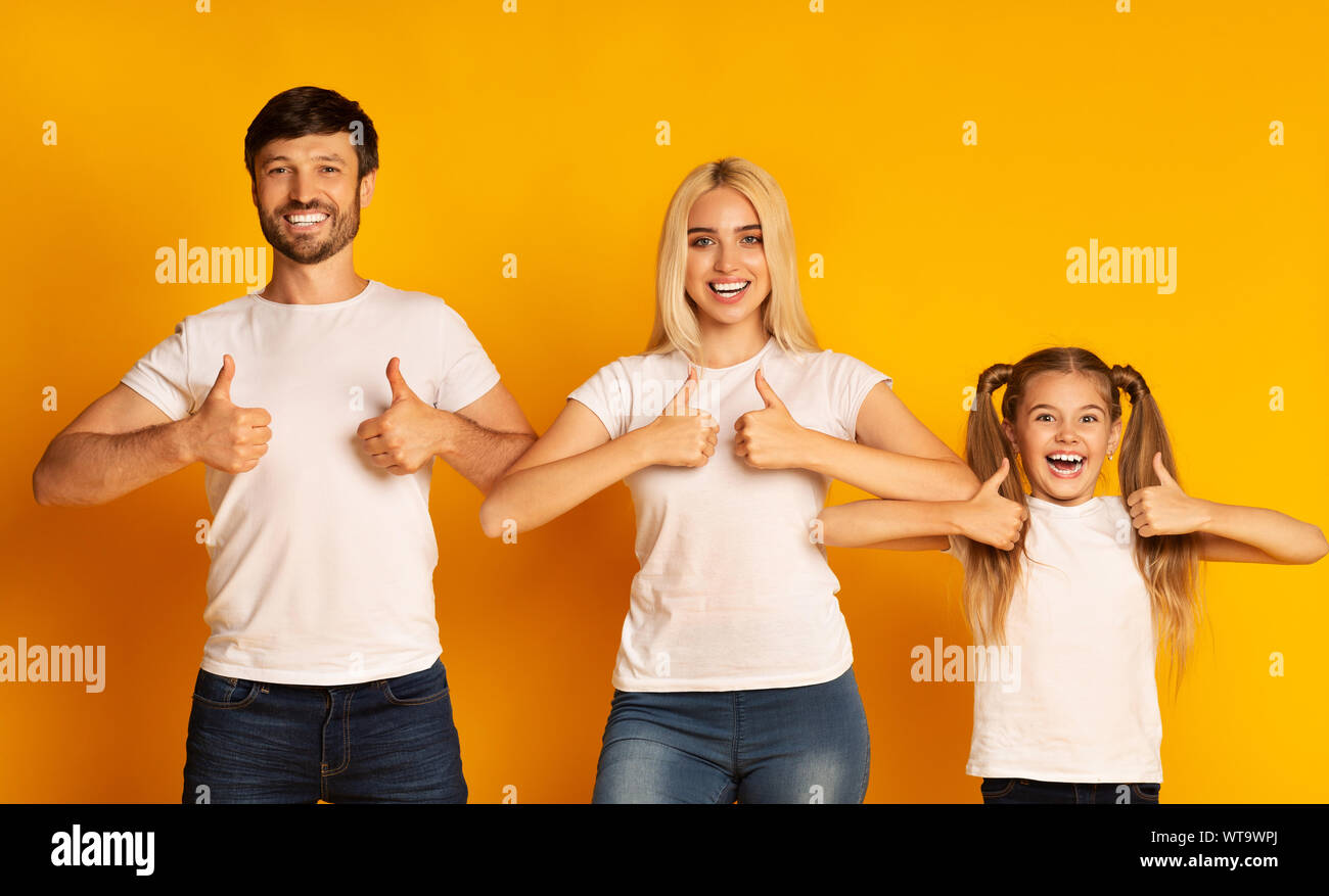 Parents And Daughter Gesturing Thumbs Up, Studio Shot Stock Photo - Alamy
