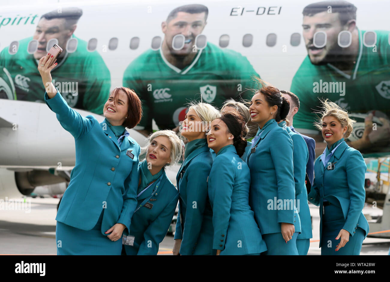 Aer Lingus cabin crew take a selfie with the plane at Dublin Airport as ...