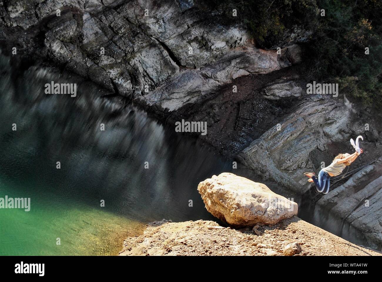 Woman jumping rock formation hi-res stock photography and images - Alamy
