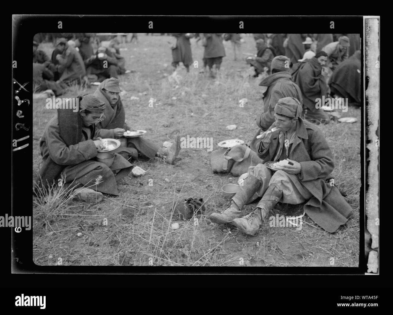 Men eating on ground Stock Photo - Alamy