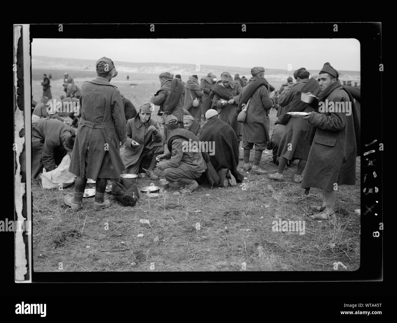 Men eating on ground Stock Photo - Alamy