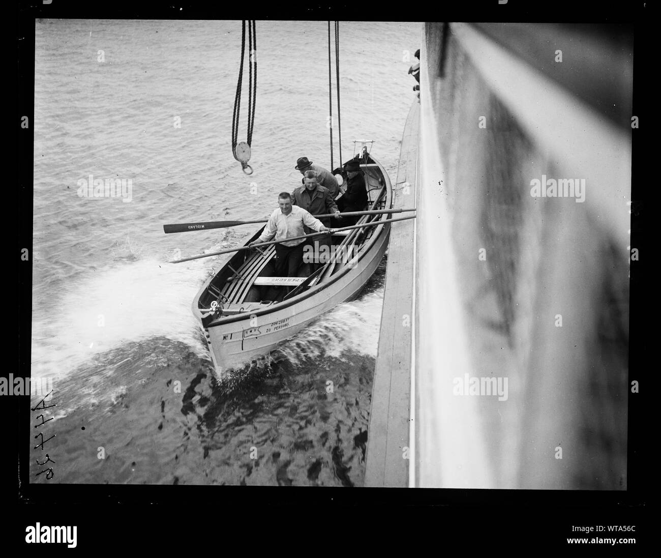 Men in life boat Stock Photo - Alamy